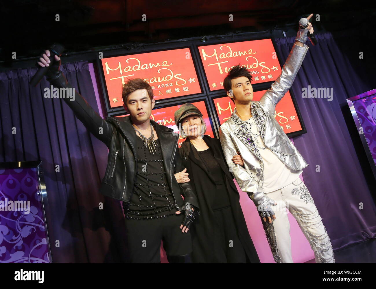 Taiwanese singer Jay Chou (left) and his mother (center)pose beside his ...