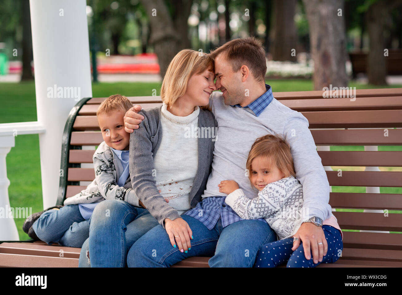 Happy family with two kids having fun together in the park outdoor ...