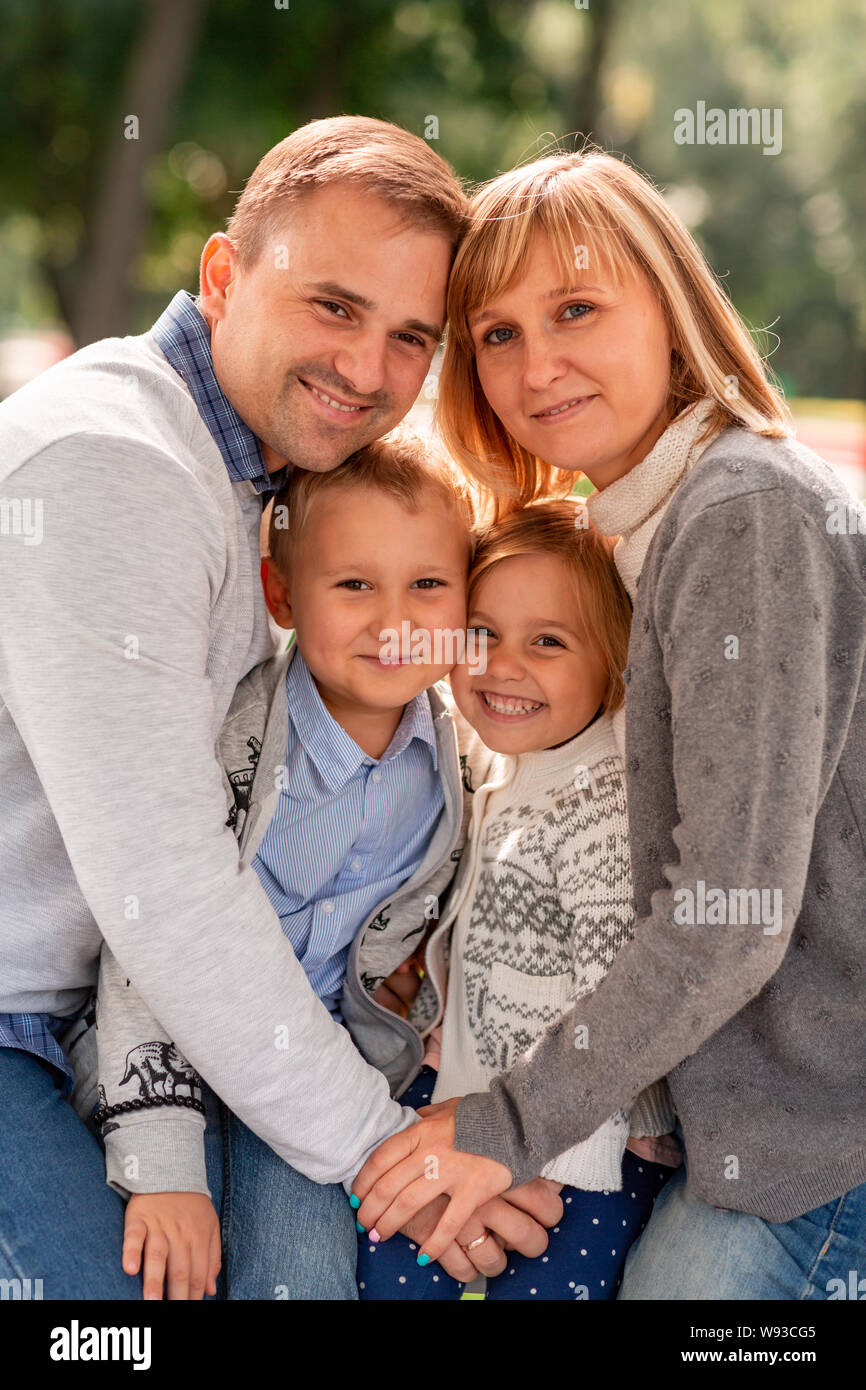 Happy family with two kids having fun together in the park outdoor ...