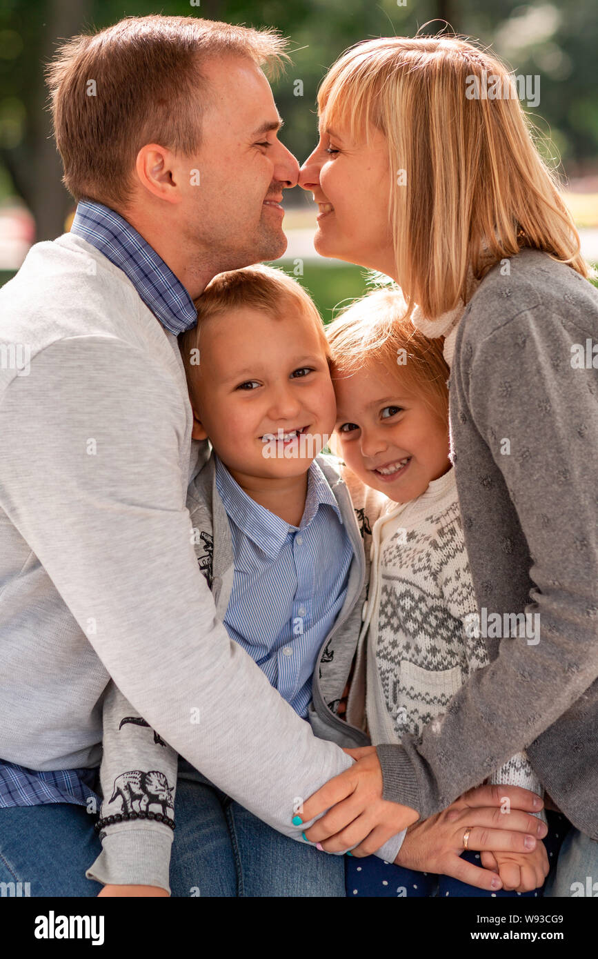 Happy family with two kids having fun together in the park outdoor ...