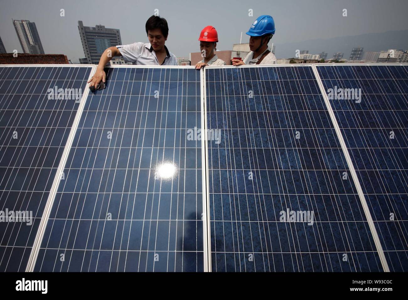 --FILE--Chinese workers install a solar panel at a photovoltaic (PV ...