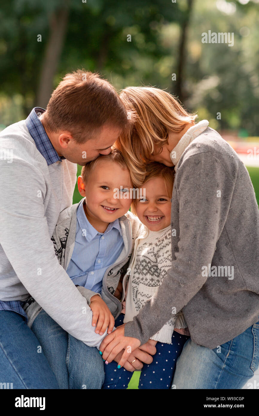 Happy family with two kids having fun together in the park outdoor ...