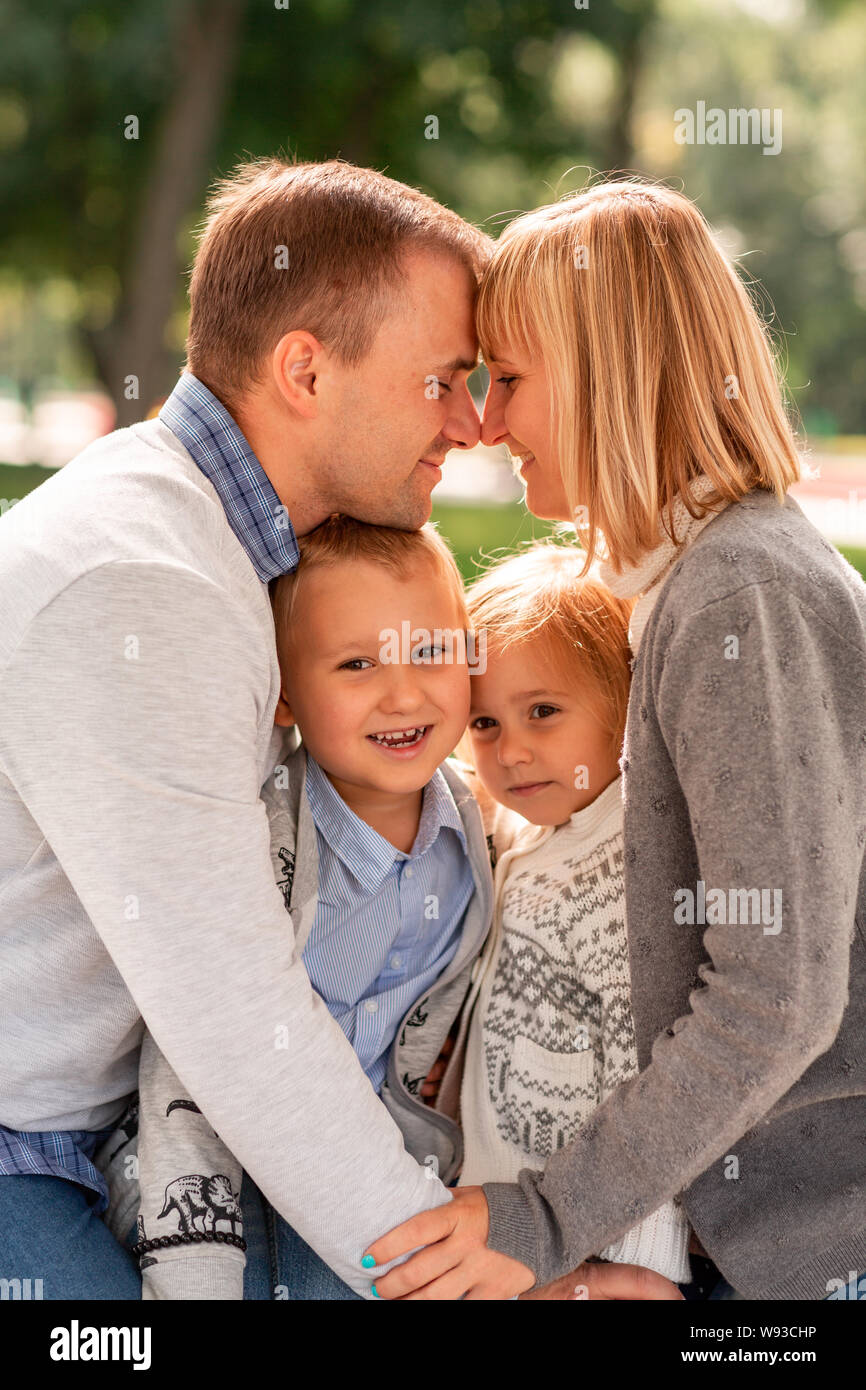 Happy family with two kids having fun together in the park outdoor ...