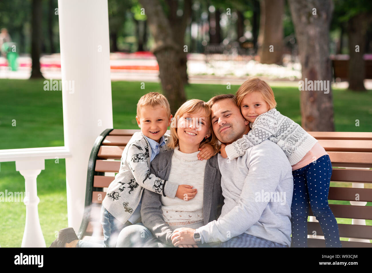 Happy family with two kids having fun together in the park outdoor ...