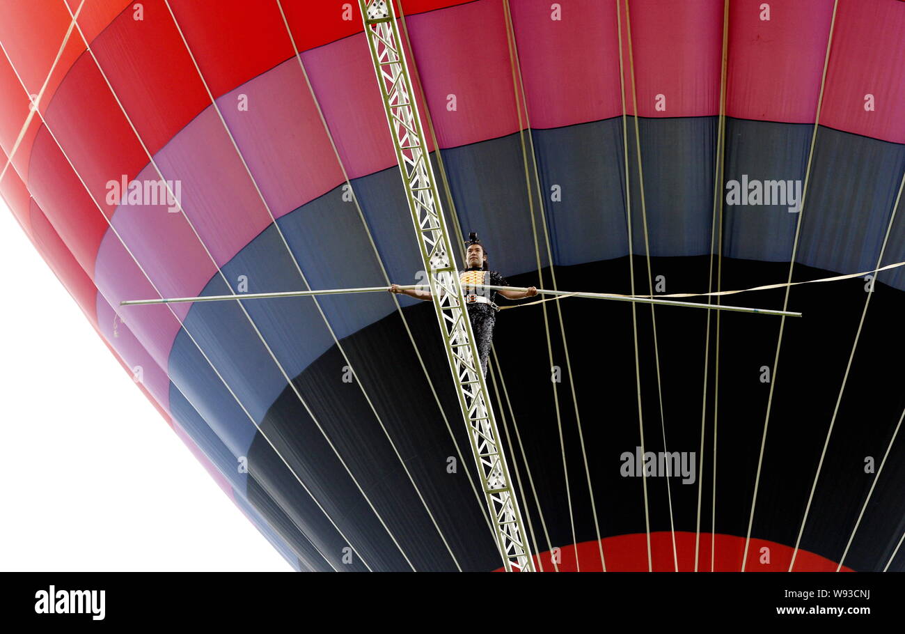 Chinese Uighur tightrope walker Aisikaier Wubulikaisimu walks on a ...
