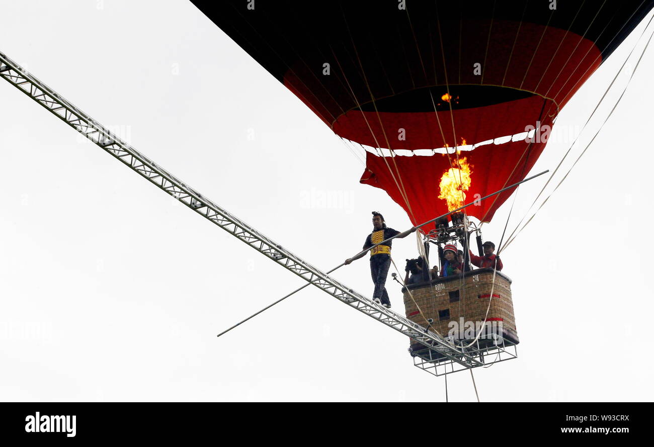 Chinese Uighur tightrope walker Aisikaier Wubulikaisimu walks on a ...