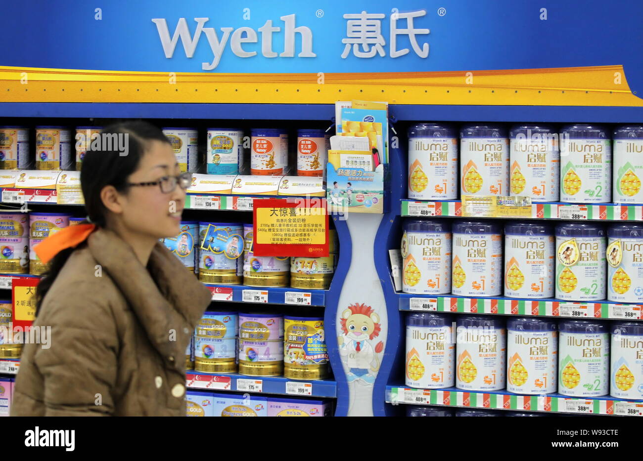 --FILE--A customer walks past tins of milk powder of Wyeth at a ...
