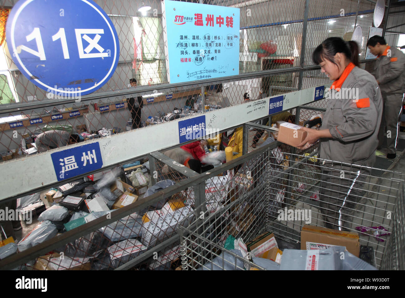 Chinese workers sort parcels, most of which come from online shopping ...