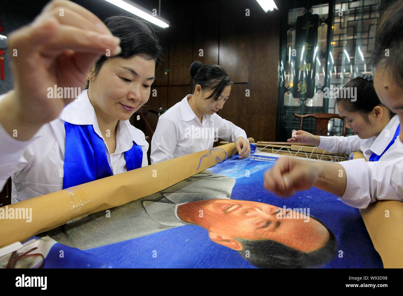 --FILE--Female Chinese workers stitch to make an embroidered portrait ...