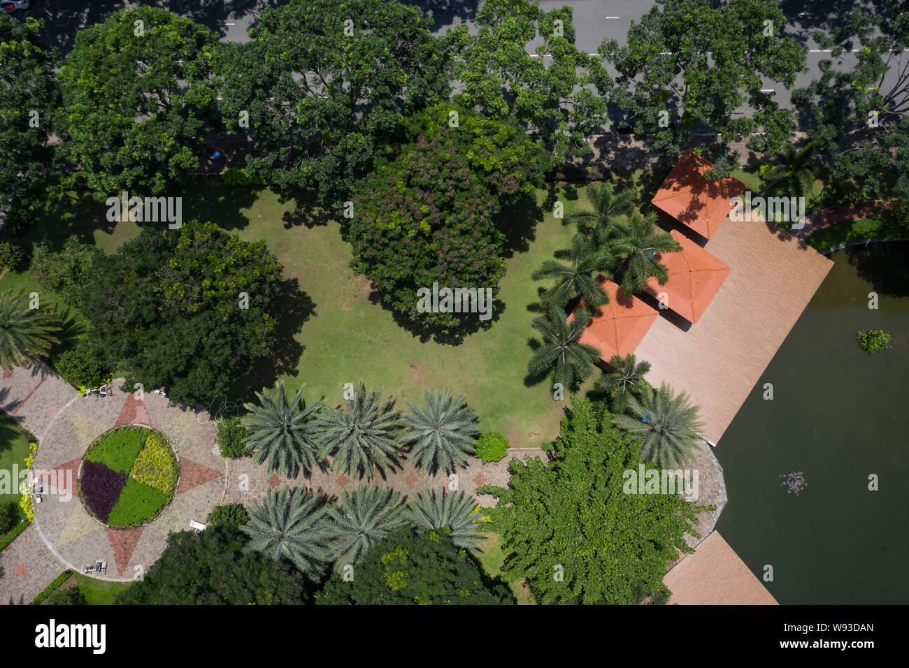 aerial view of modern urban park featuring lakes, lush gardens, bridges ...