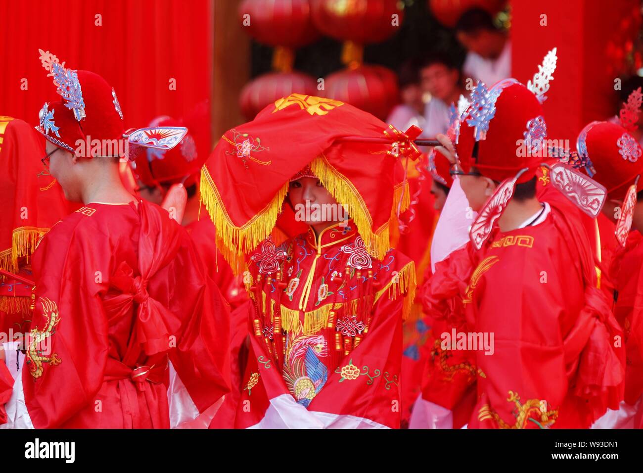 Chinese newly-weds dressed in traditional Chinese wedding costumes take ...