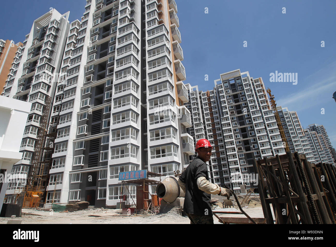 Chinese migrant workers labor at the construction site of a residential ...