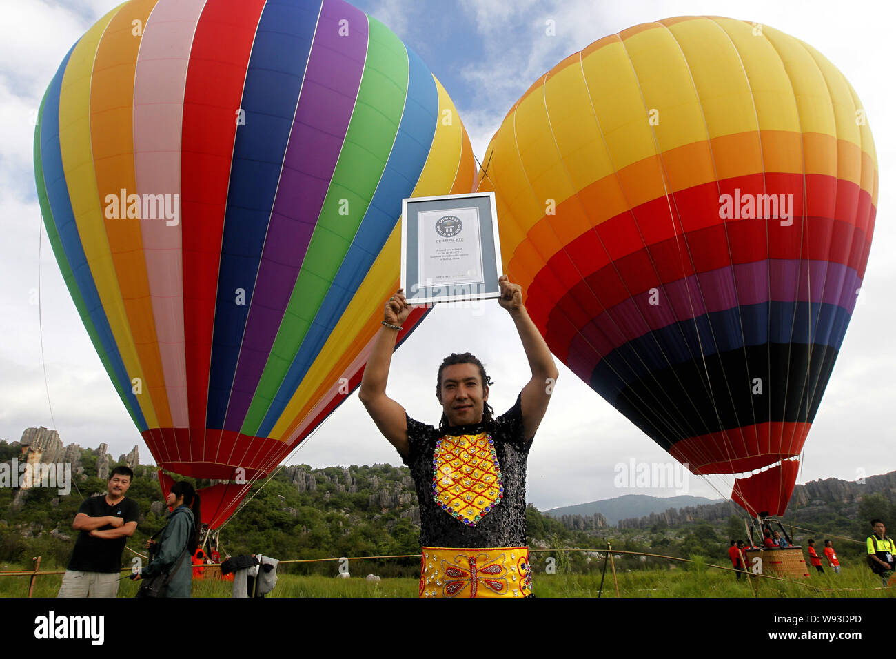 Chinese Uighur tightrope walker Aisikaier Wubulikaisimu holds up his ...