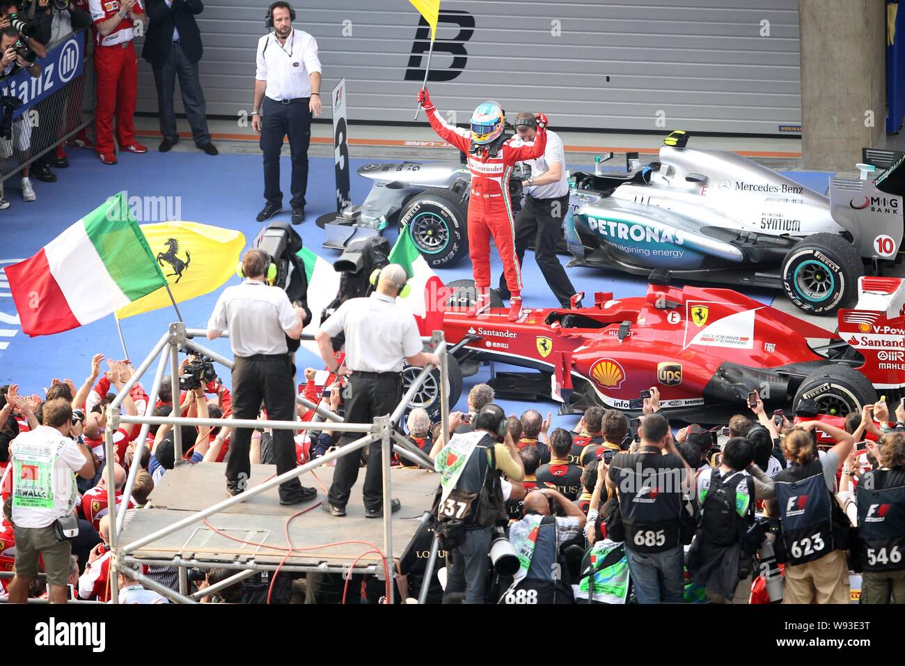 Spanish F1 driver Fernando Alonso of Ferrari, center, celebrates after ...