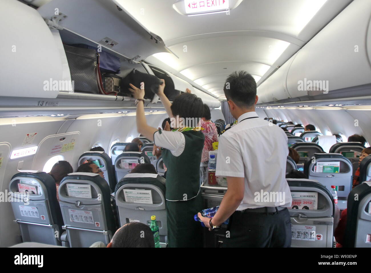 --FILE--Cabin crew members of Spring Airlines serve passengers during a ...