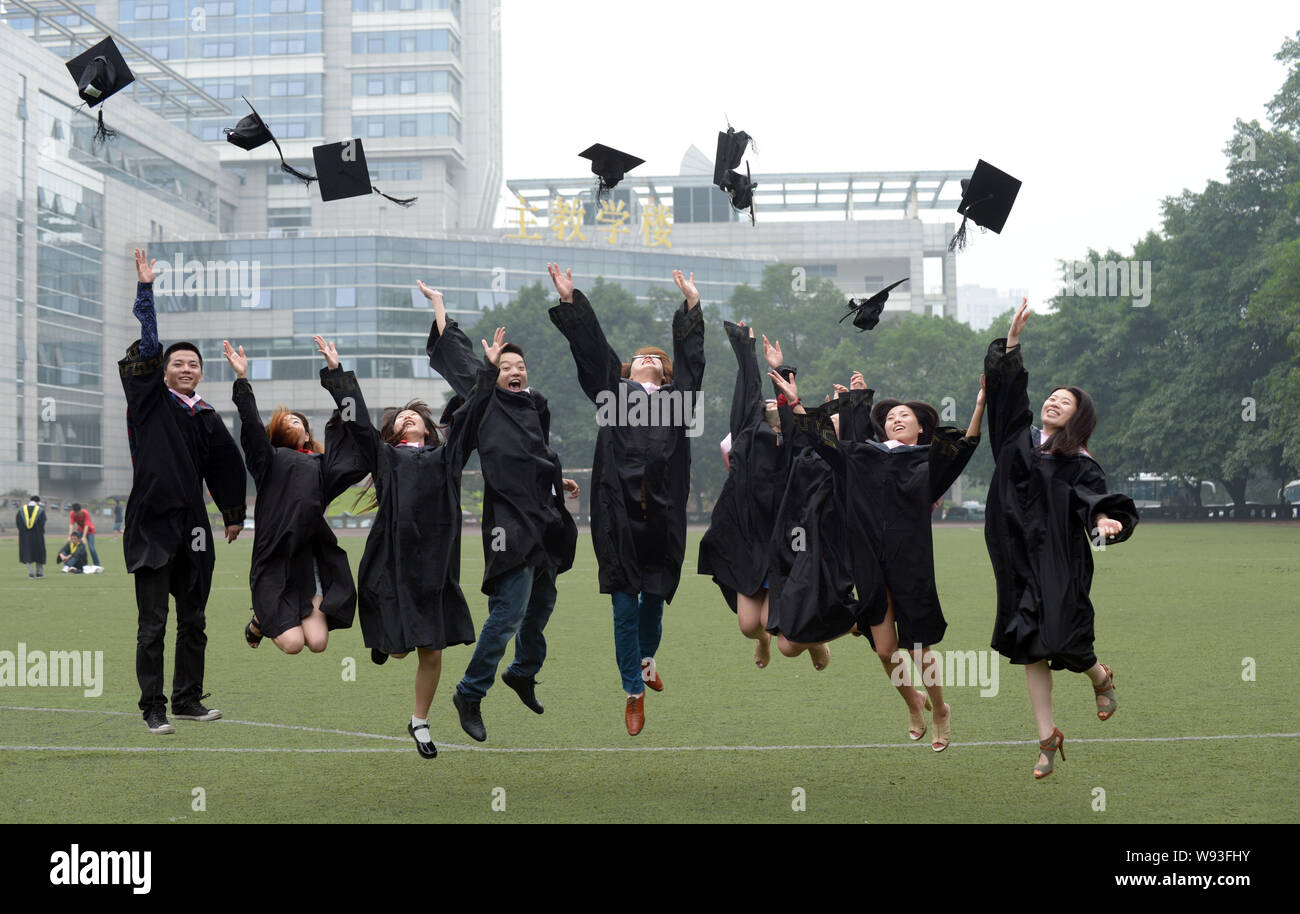 --FILE--Chinese graduates throw their academic hats into the air after ...