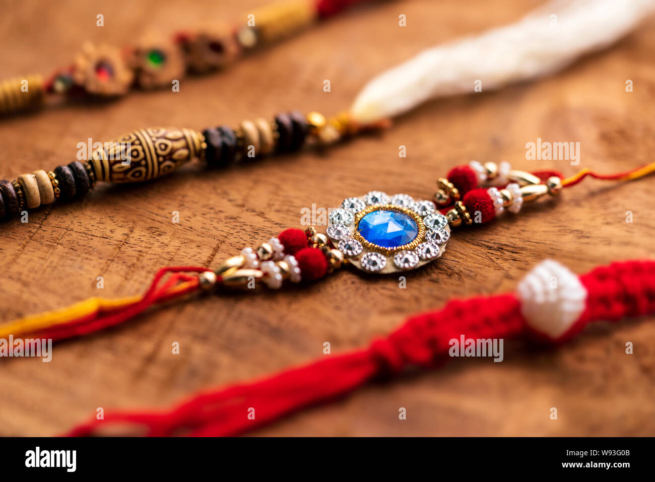 Different types of traditional handmade rakhi on a wooden surface ...