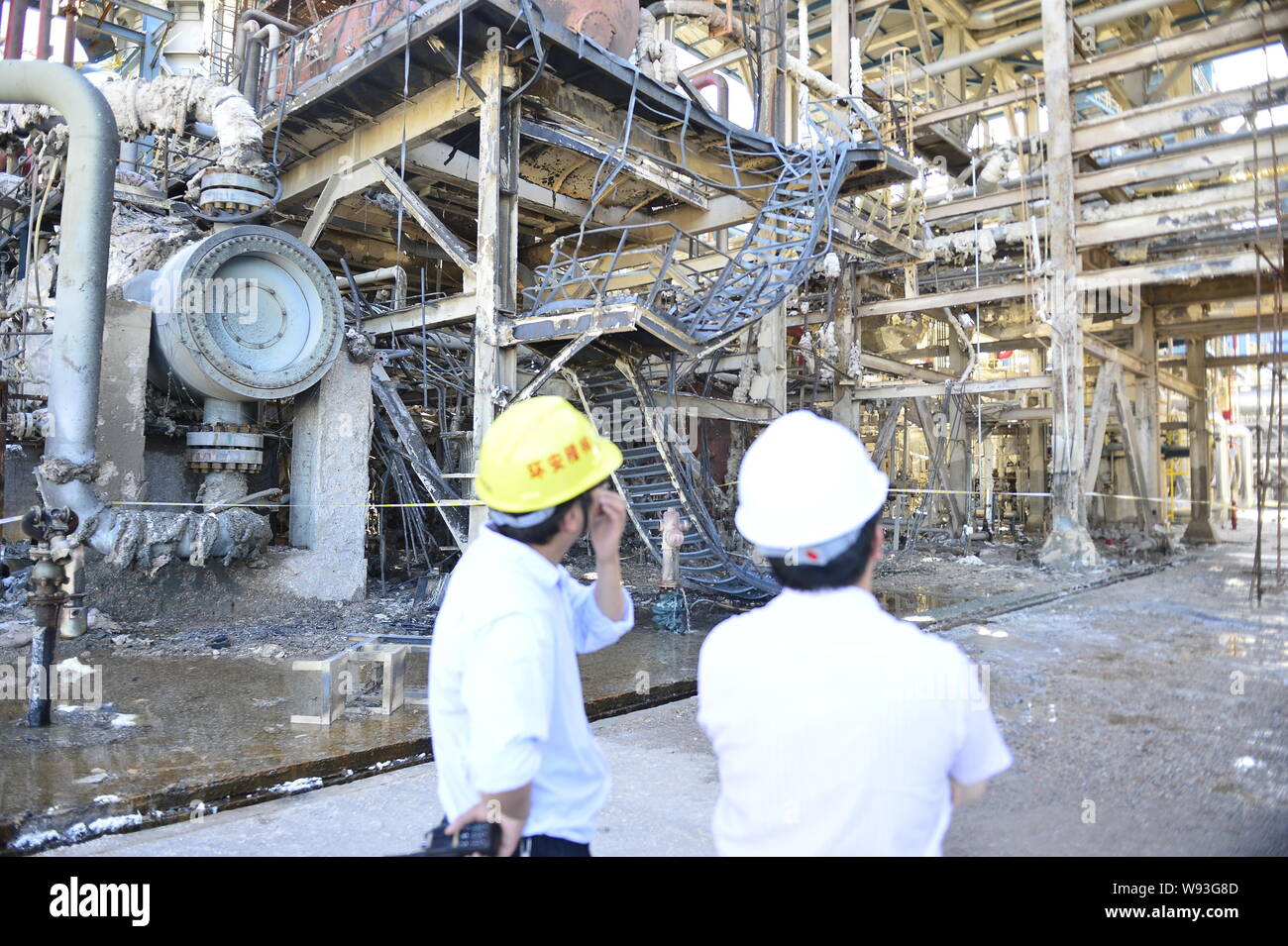 Chinese investigators look at the facility damaged in the explosion at ...