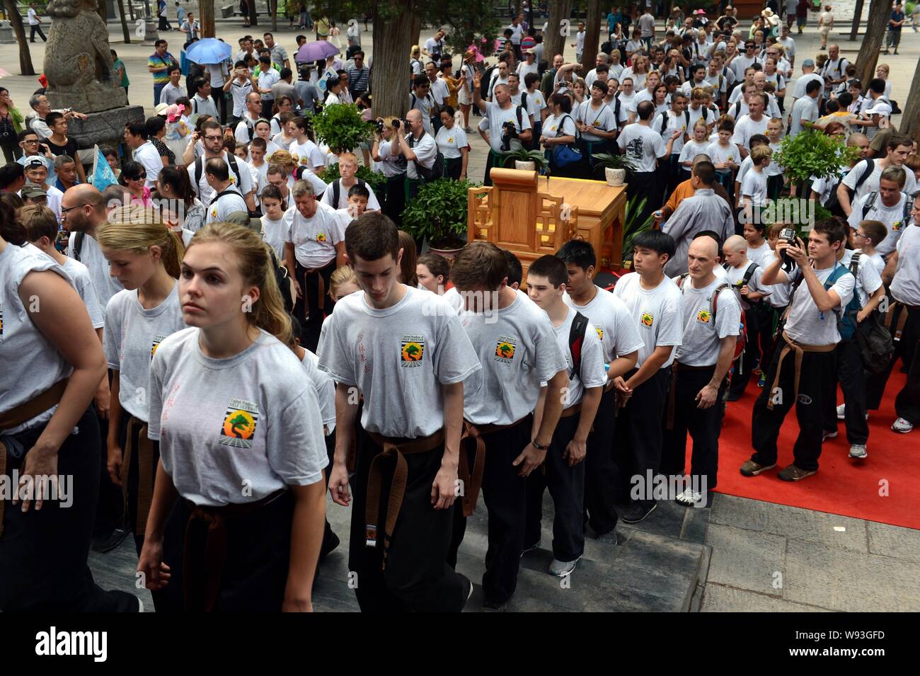 Foreign students queue up to be awarded graduation certificates during ...
