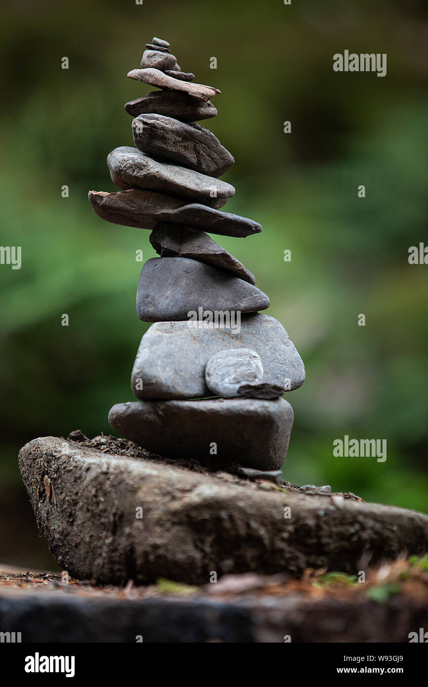 Stack of Stones in the Garden with Green Background Stock Photo - Alamy