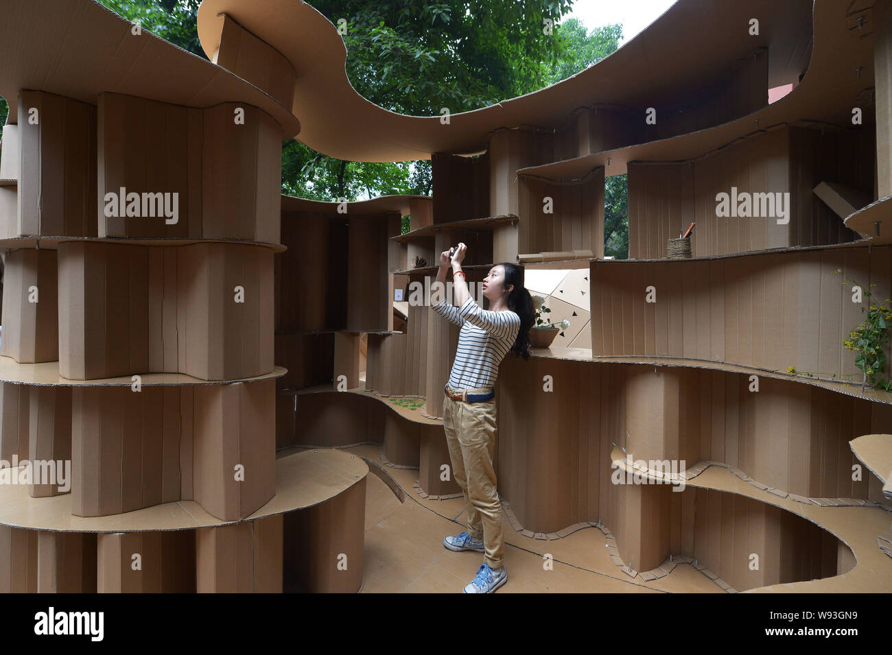 A Chinese student takes photos of a house made of cardboard at ...