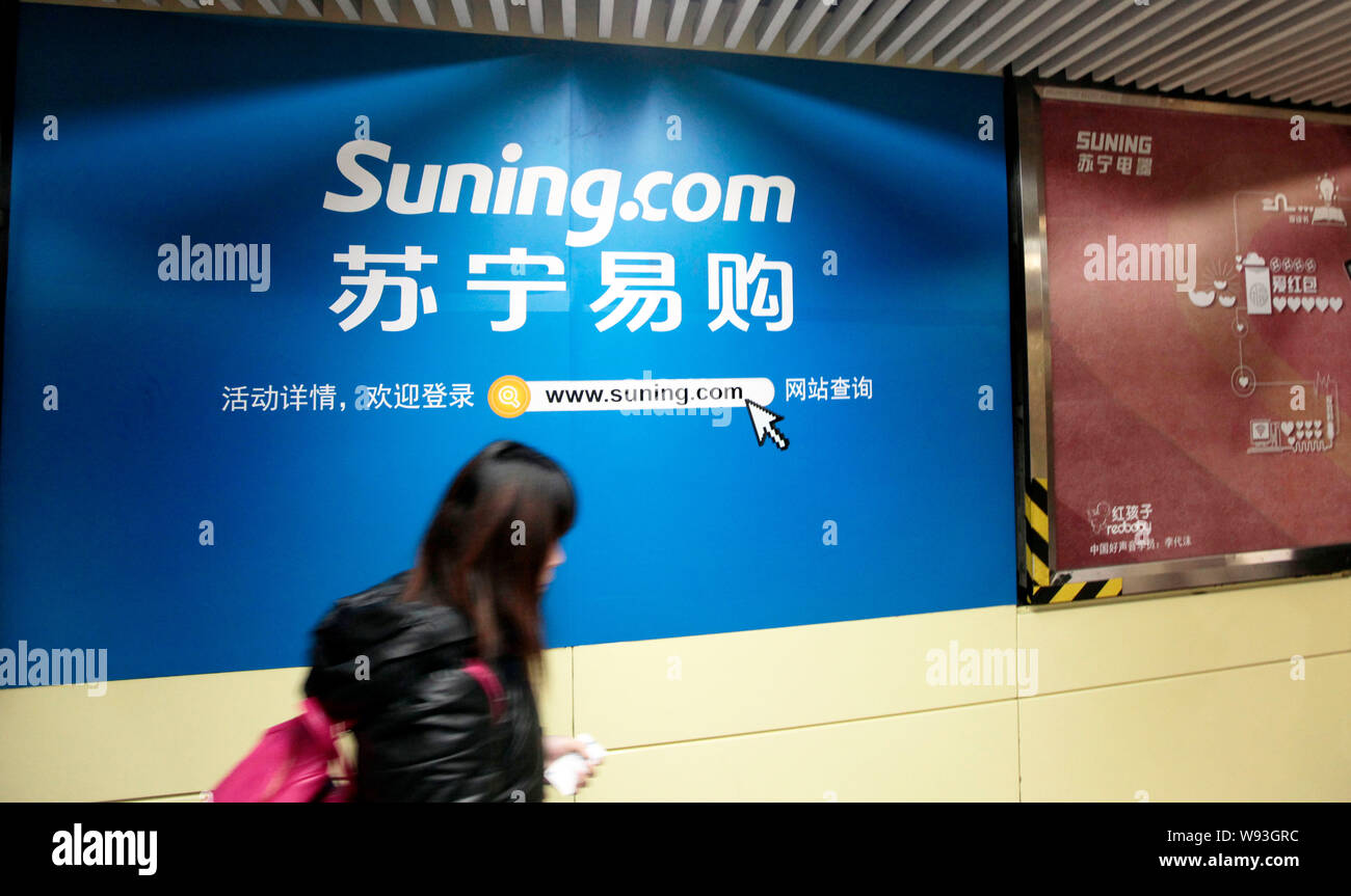 --FILE--A pedestrian walks past an advertisement of online shopping ...