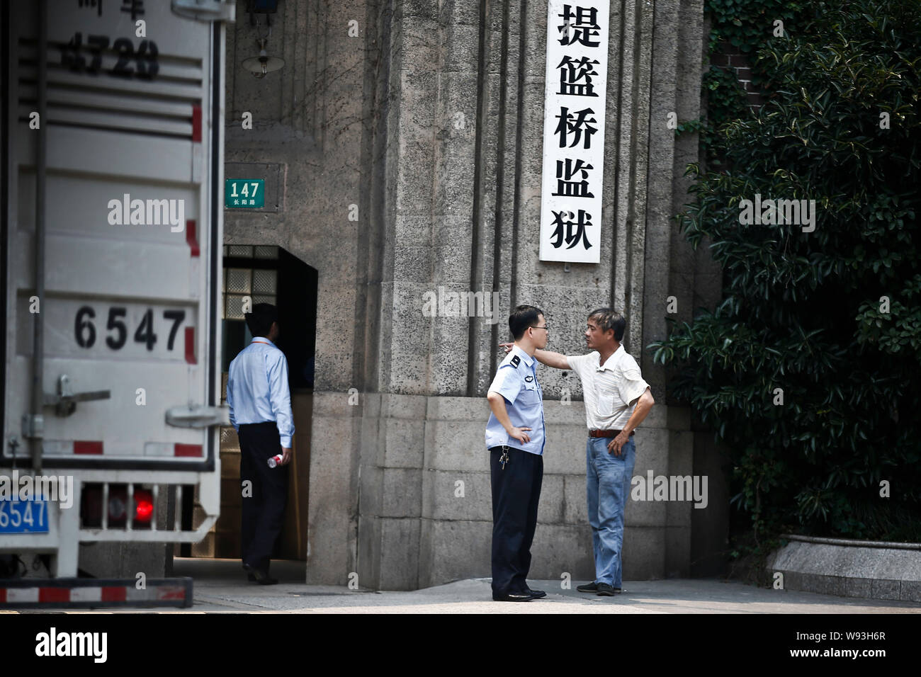A Chinese man talks with a police officer outside Tilanqiao Prison in ...