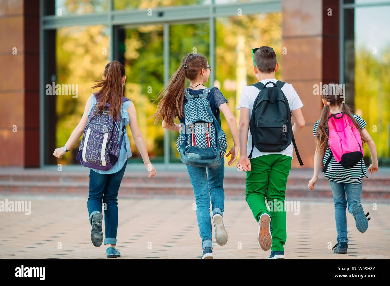 Group of kids going to school together Stock Photo - Alamy