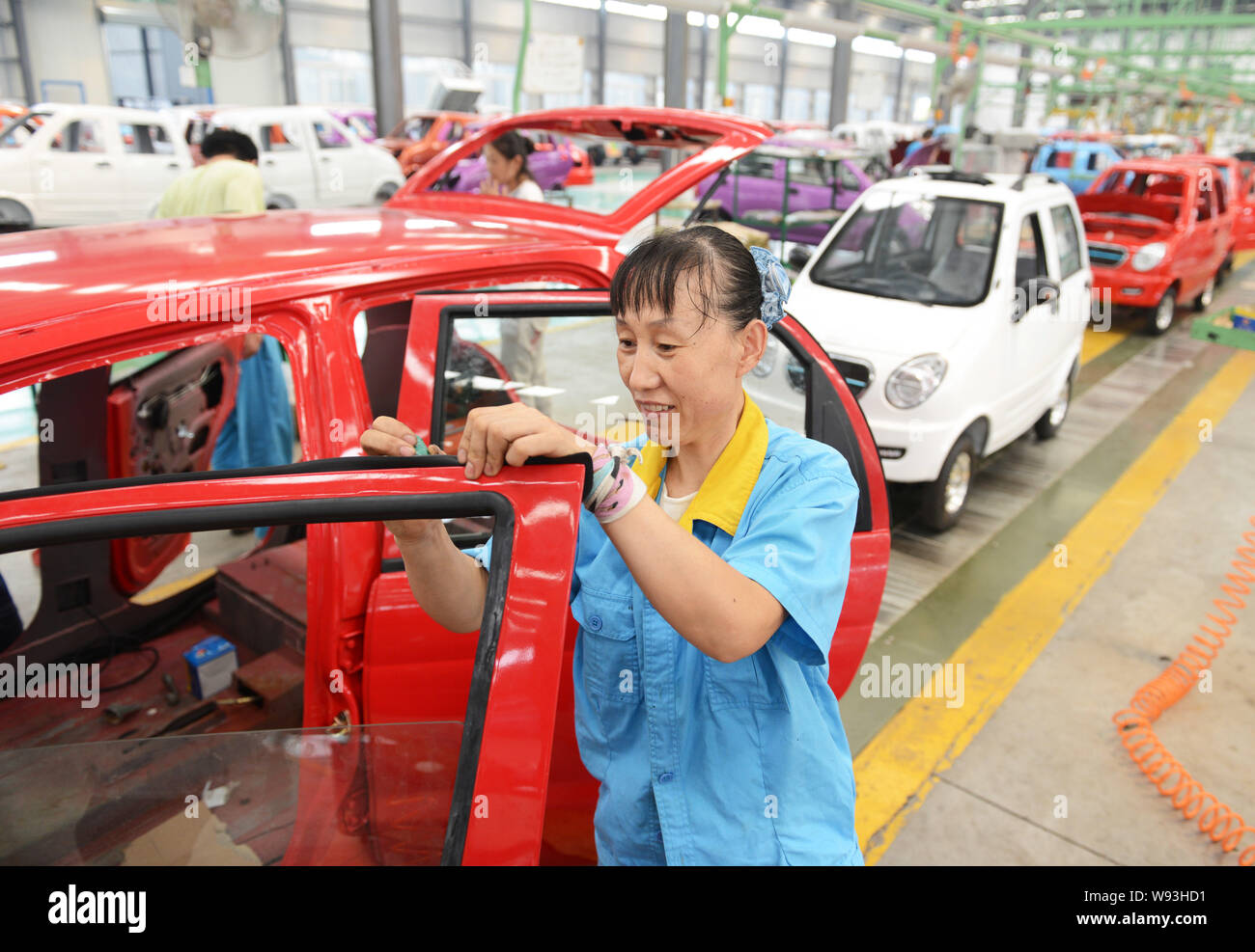 --FILE--Chinese workers assemble cars on the assembly line at an auto ...
