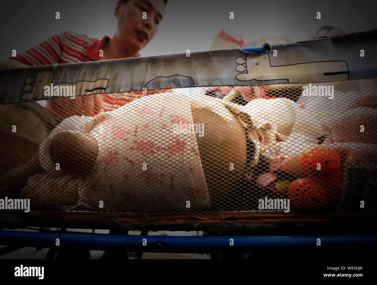 Chinese father Wang Wenjun attends his 15-month-old daughter Wang Feng ...