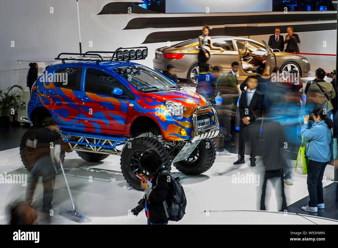 Visitors look at a refitted Gleagle Panda of Geely during the 15th ...