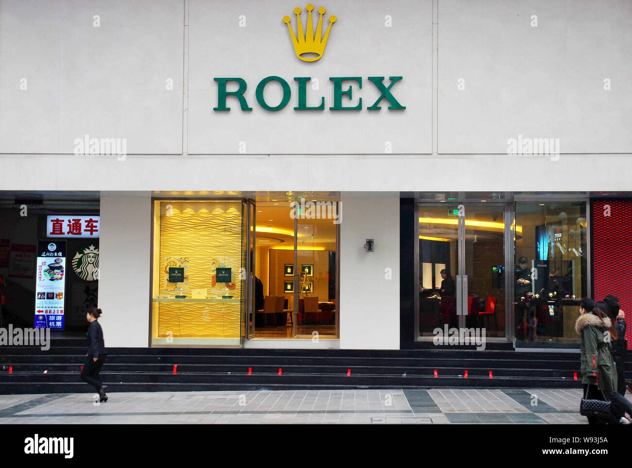 --FILE--Pedestrians walk past a store of luxury watch brand Rolex in ...
