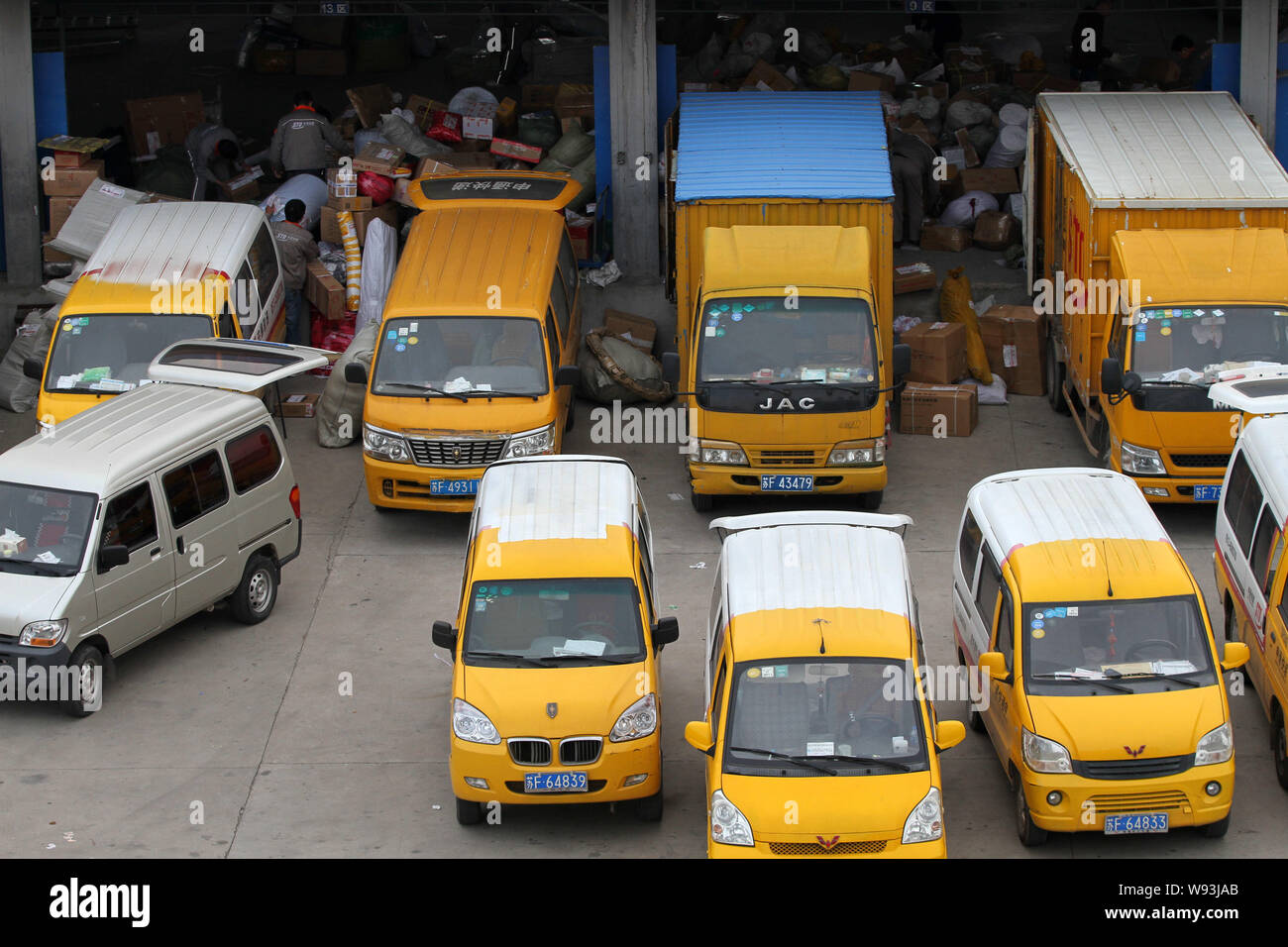 Chinese workers load parcels, most of which come from online shopping ...
