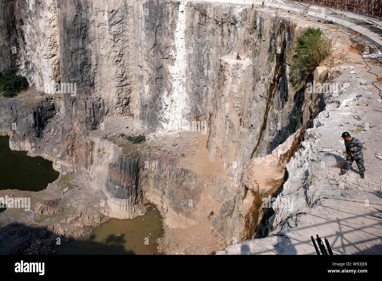 A worker looks down at the construction site of InterContinental Shimao ...