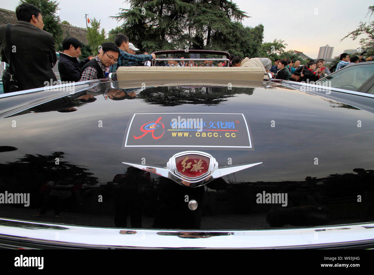 Visitors look at an old timer car of Red Flag or Hongqi during the ...