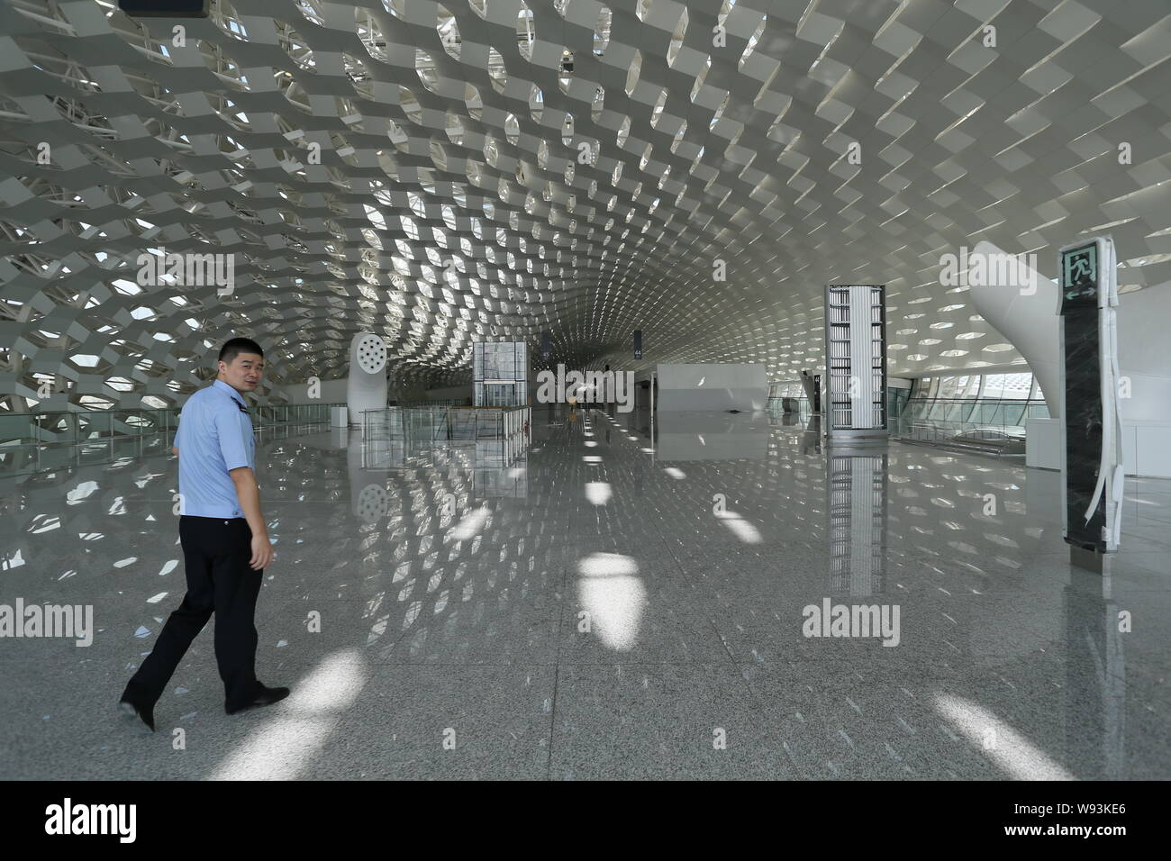 A police officer walks in the Terminal 3 of Shenzhen Baoan ...