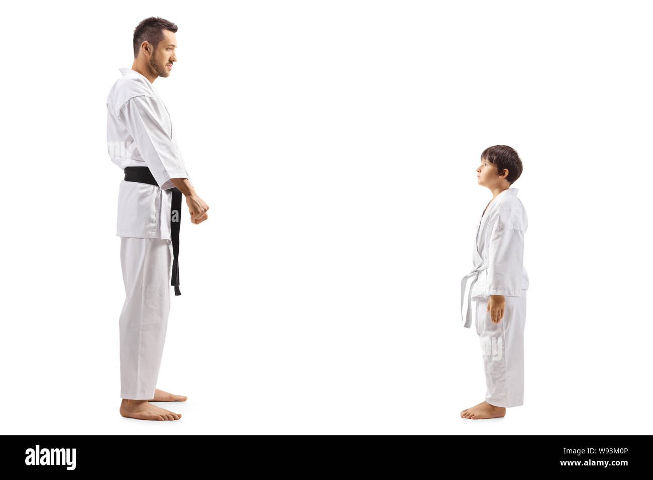Full length profile shot of a karate kid standing and looking at his ...