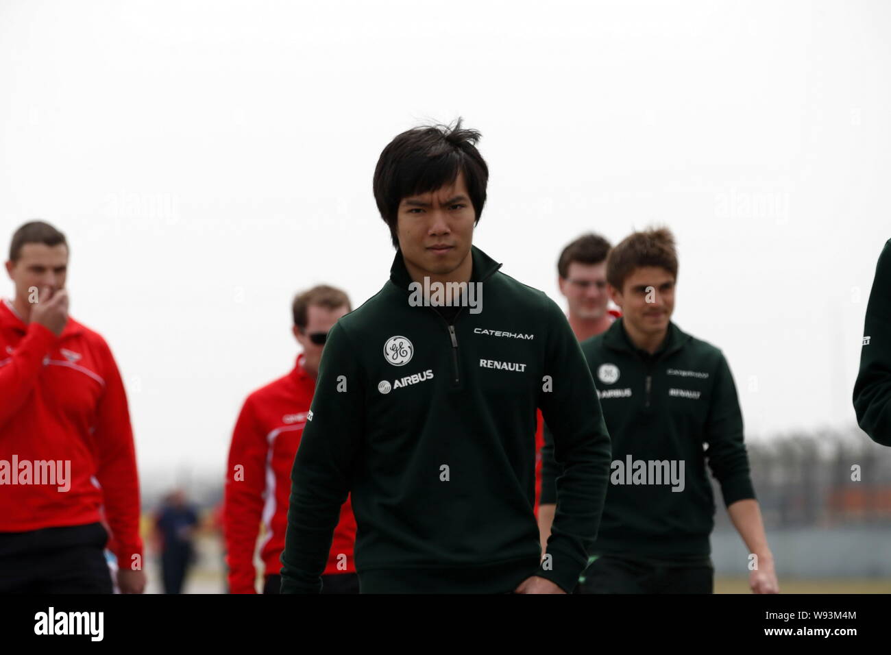 Chinese racer Ma Qinghua of Caterham, front, his teammates and members ...