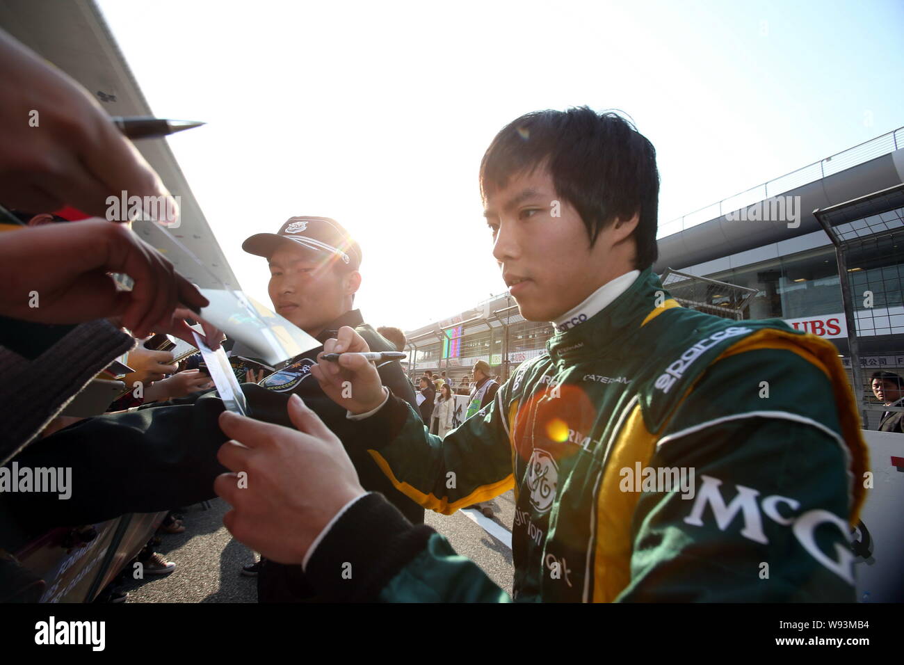 Chinese driver Ma Qinghua of Caterham signs autographs for fans at the ...