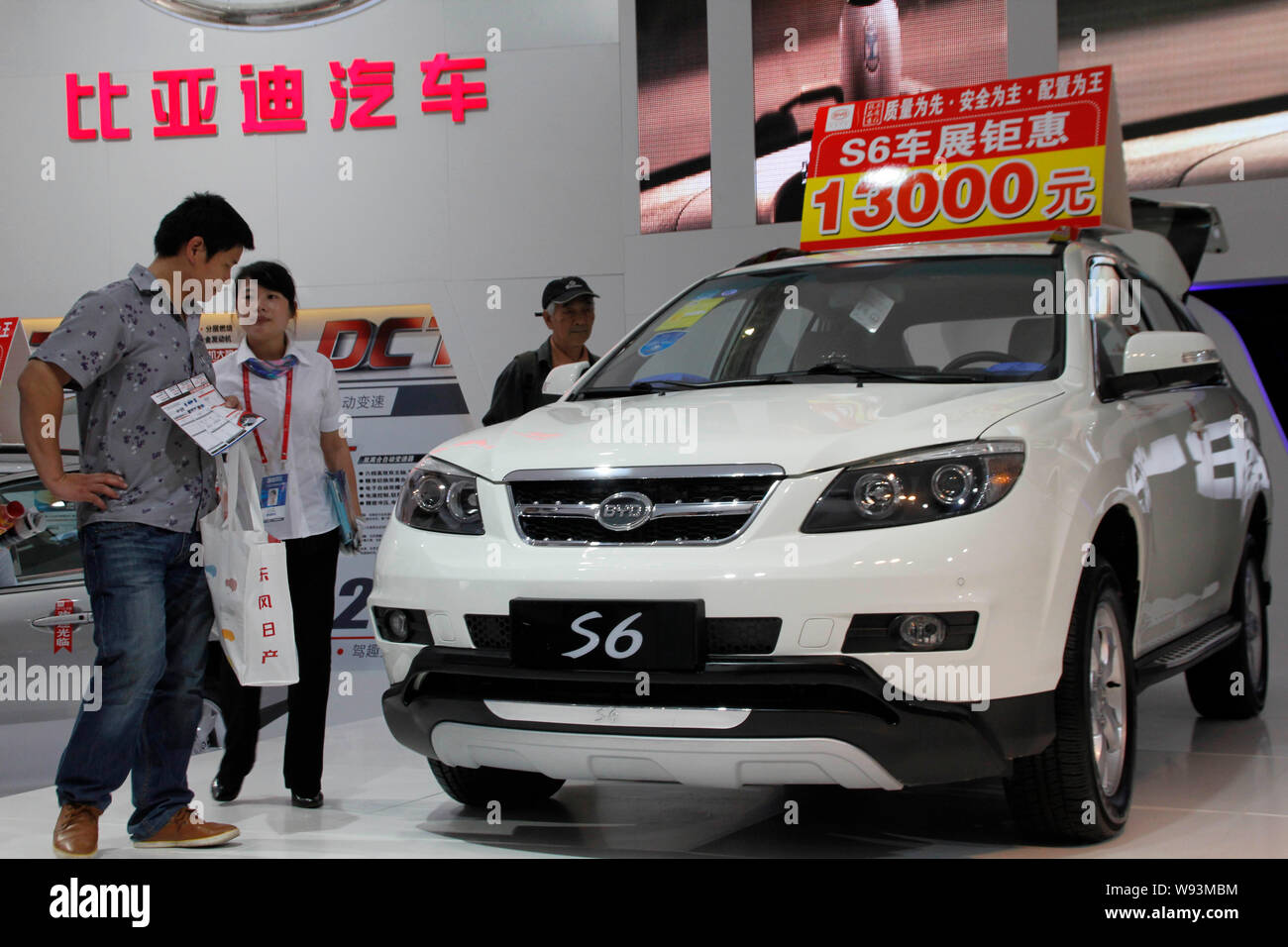 Visitors look at a BYD S6 during an auto show in Haikou city, south ...