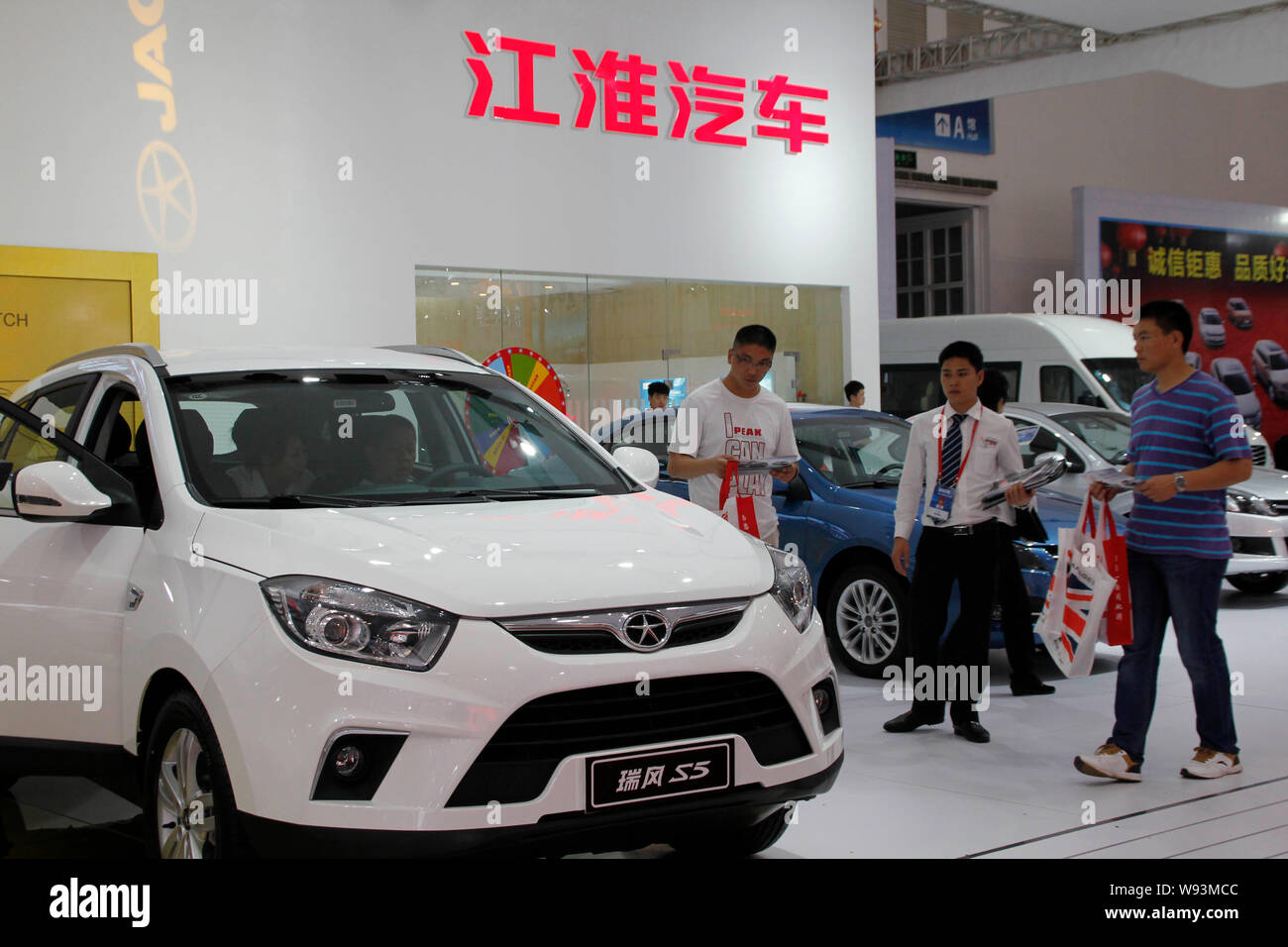 --FILE--Visitors look at JAC cars during an auto show in Haikou city ...