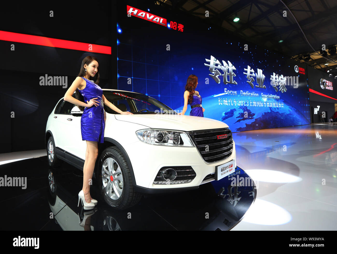 Models pose with a Haval H8 SUV of Great Wall Motors during the 15th ...