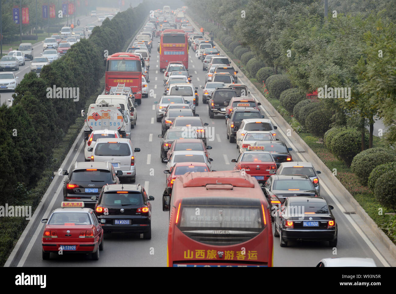 Cars and buses move slowly on an expressway in Taiyuan city, north ...