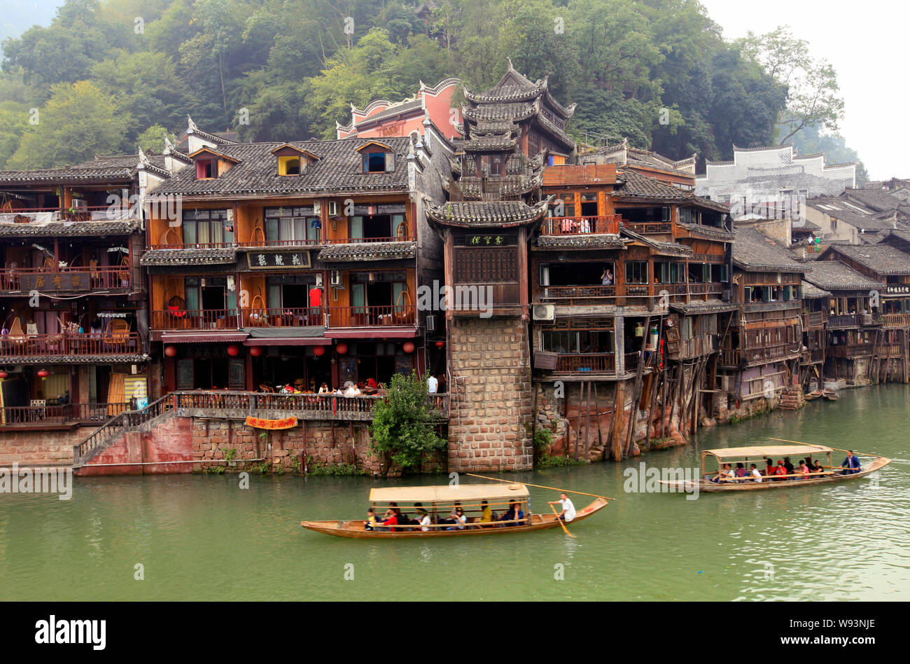 People visit the Fenghuang ancient town scenic area in during the week ...