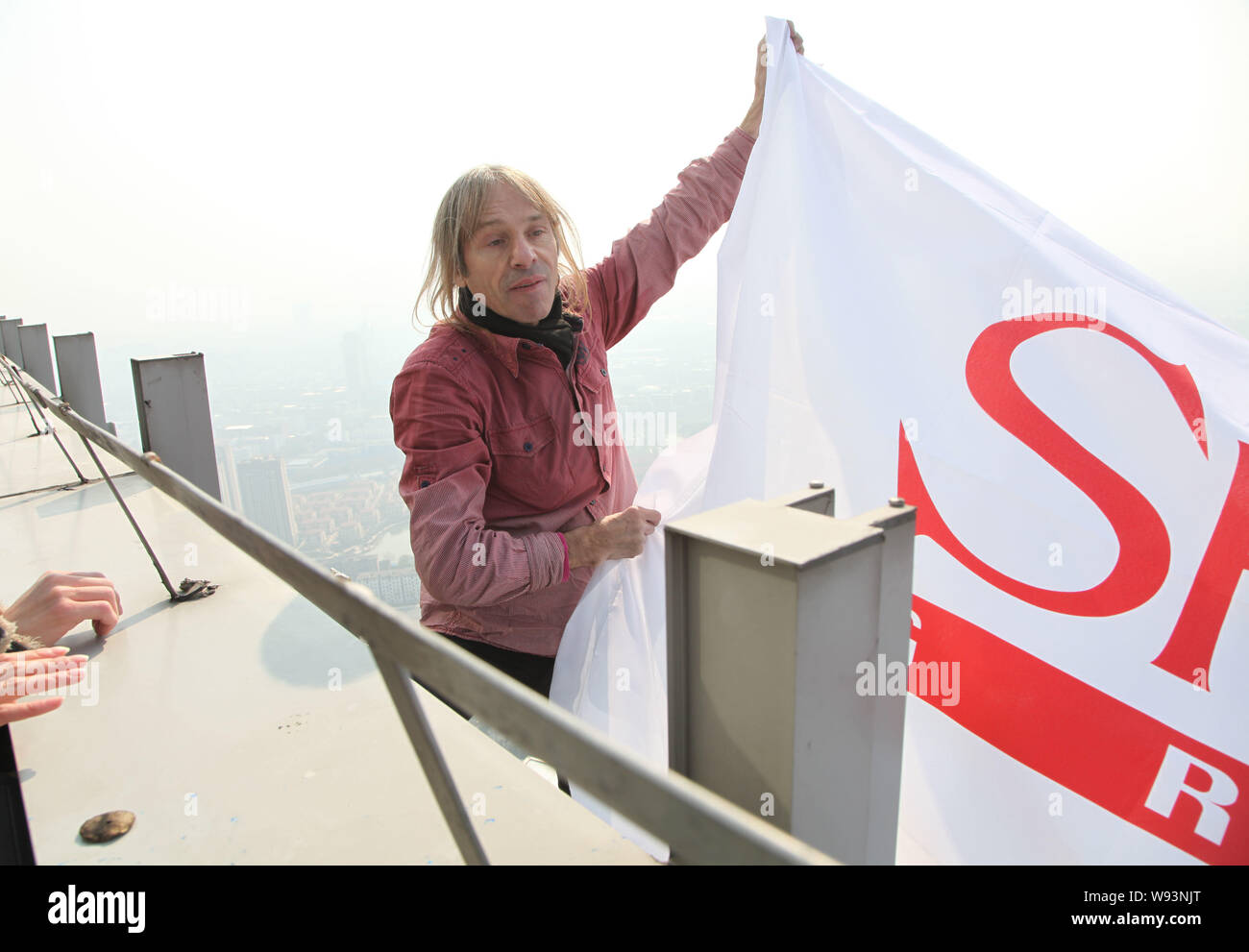 French Spiderman Alain Robert poses after finishing climbing the 288 ...