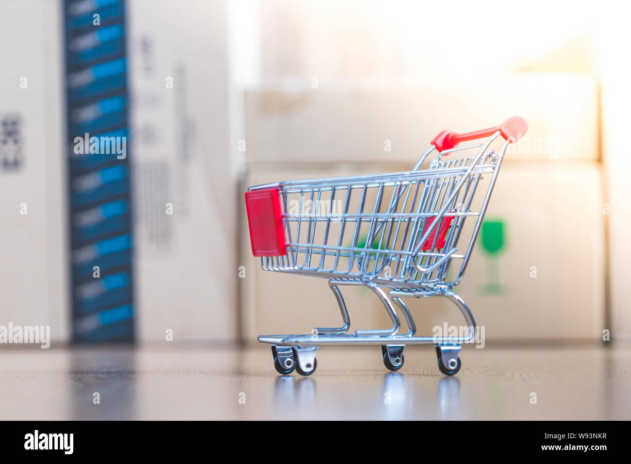 Online-Shopping and parcel service concept: Miniature shopping cart and ...