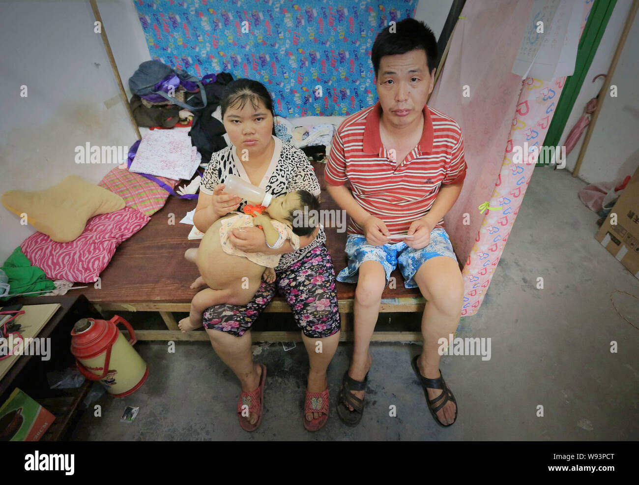 Chinese father Wang Wenjun, right, sits next to his wife Qiao Zhilan ...