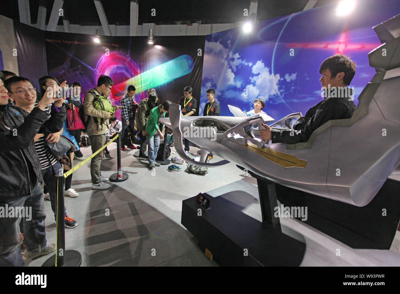 A visitor poses for photos in a model entry plug from the Neon Genesis ...