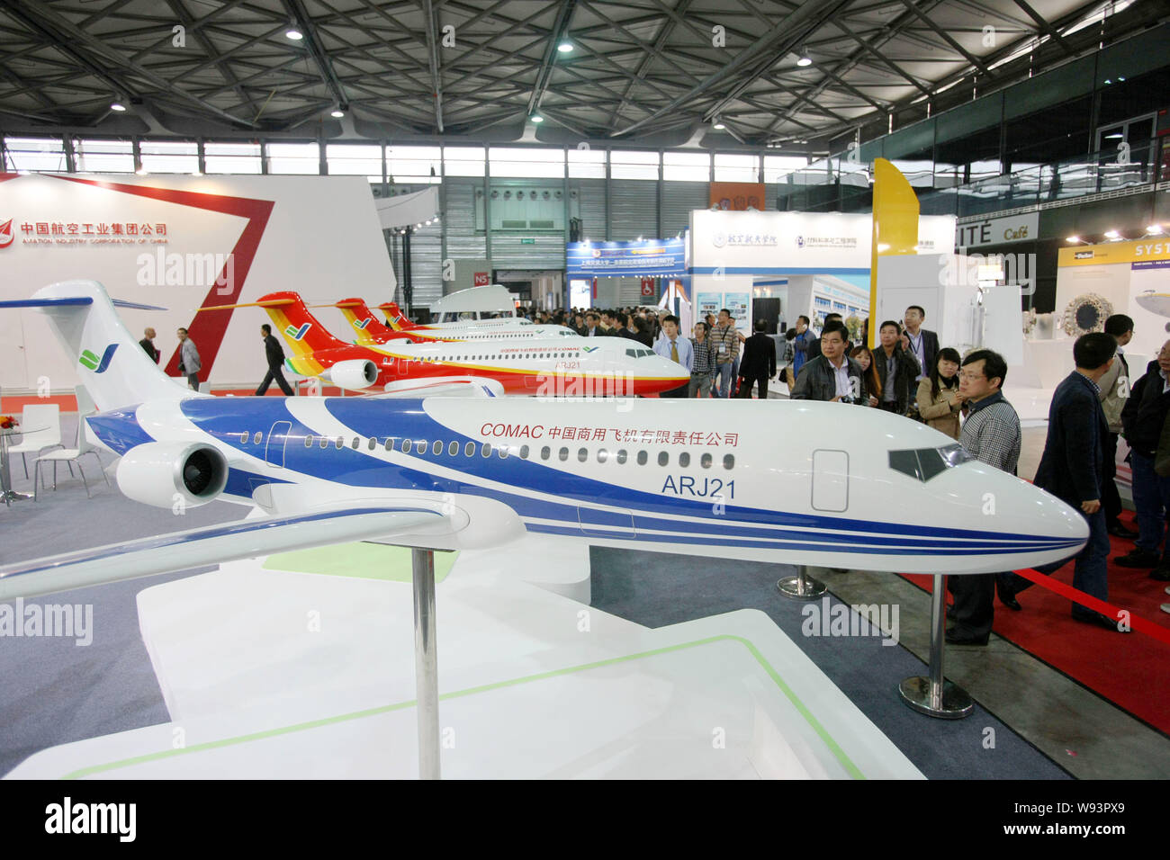 Visitors look at models of ARJ21 regional jet plane of COMAC ...