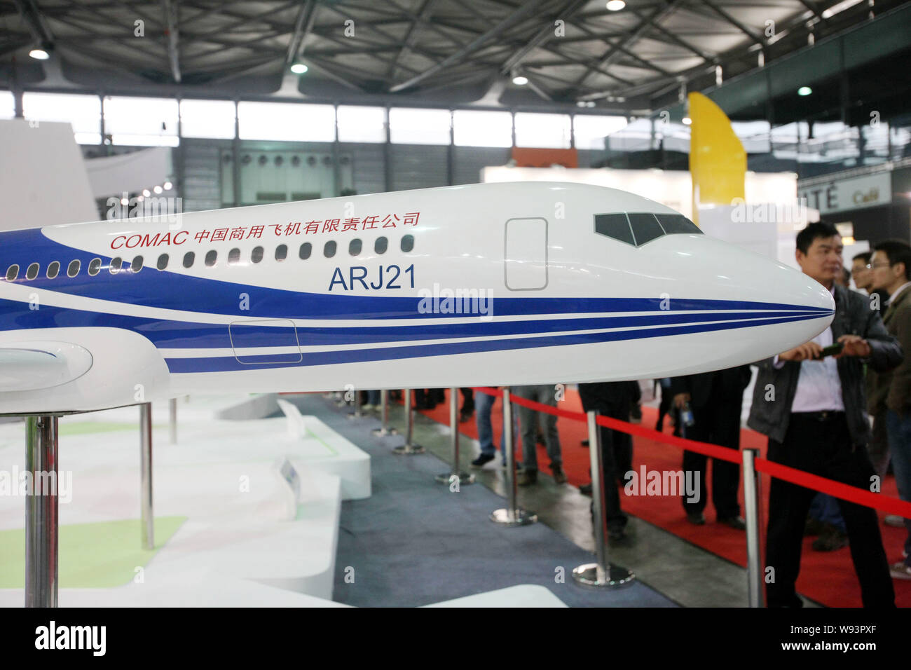 Visitors look at models of ARJ21 regional jet plane of COMAC (Commercial Aircraft Corporation of ...